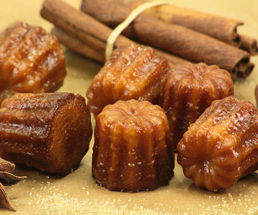 Homemade Cannelé cakes with autumn fruit minestrone